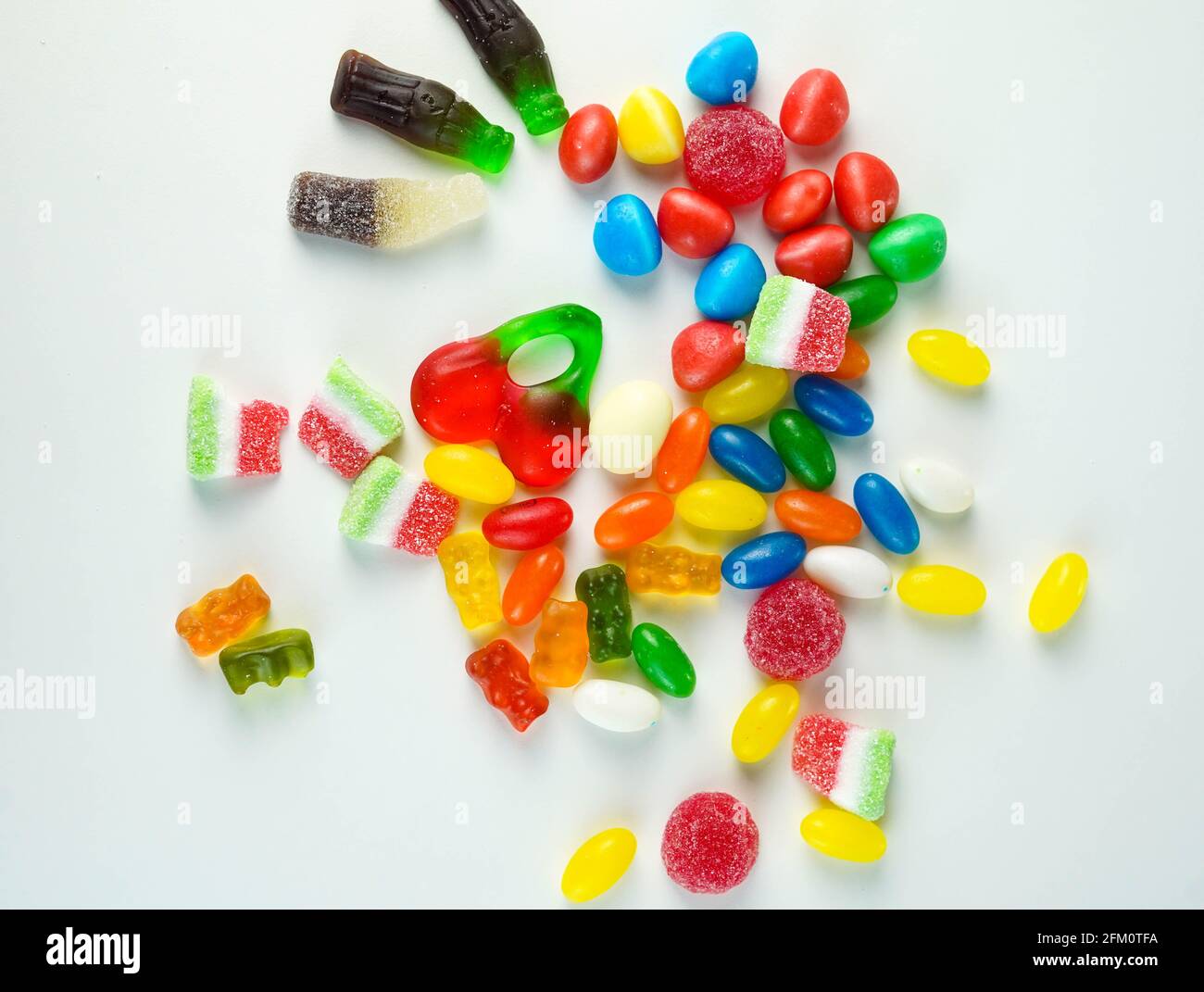 Many sweets and candies on a white background. Too much sugar concept ...