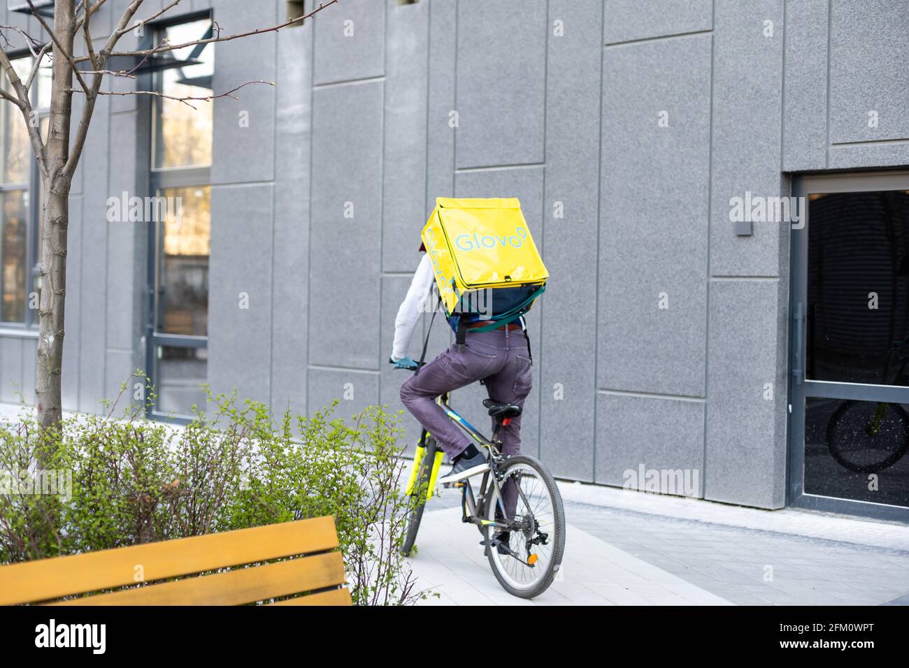 KIEV, UKRAINE - April 28, 2021: Glovo bike courier on the street ...