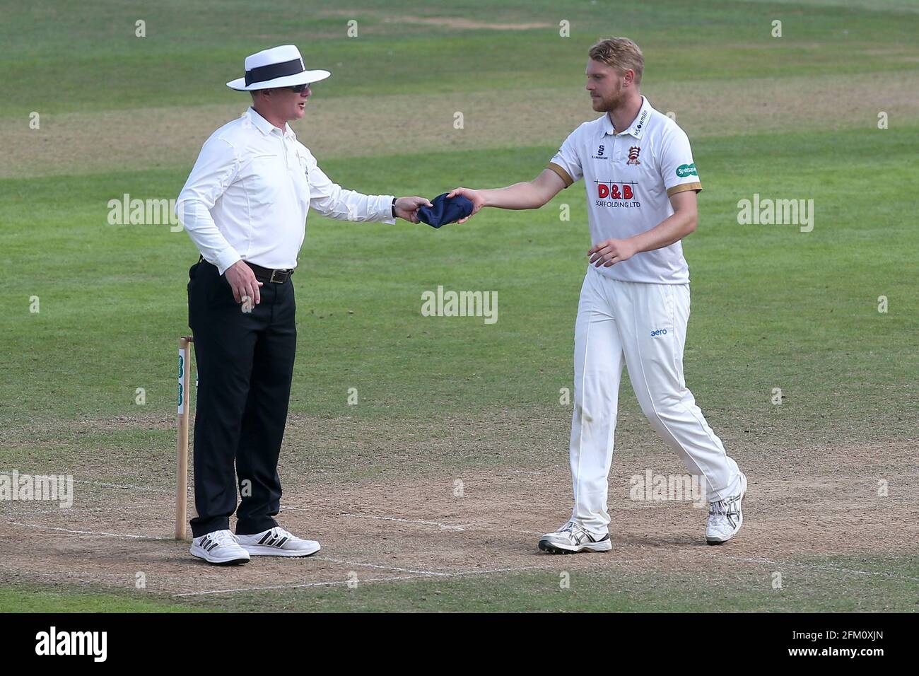 Jamie Porter of Essex takes his cap from umpire Ben Debenham during ...