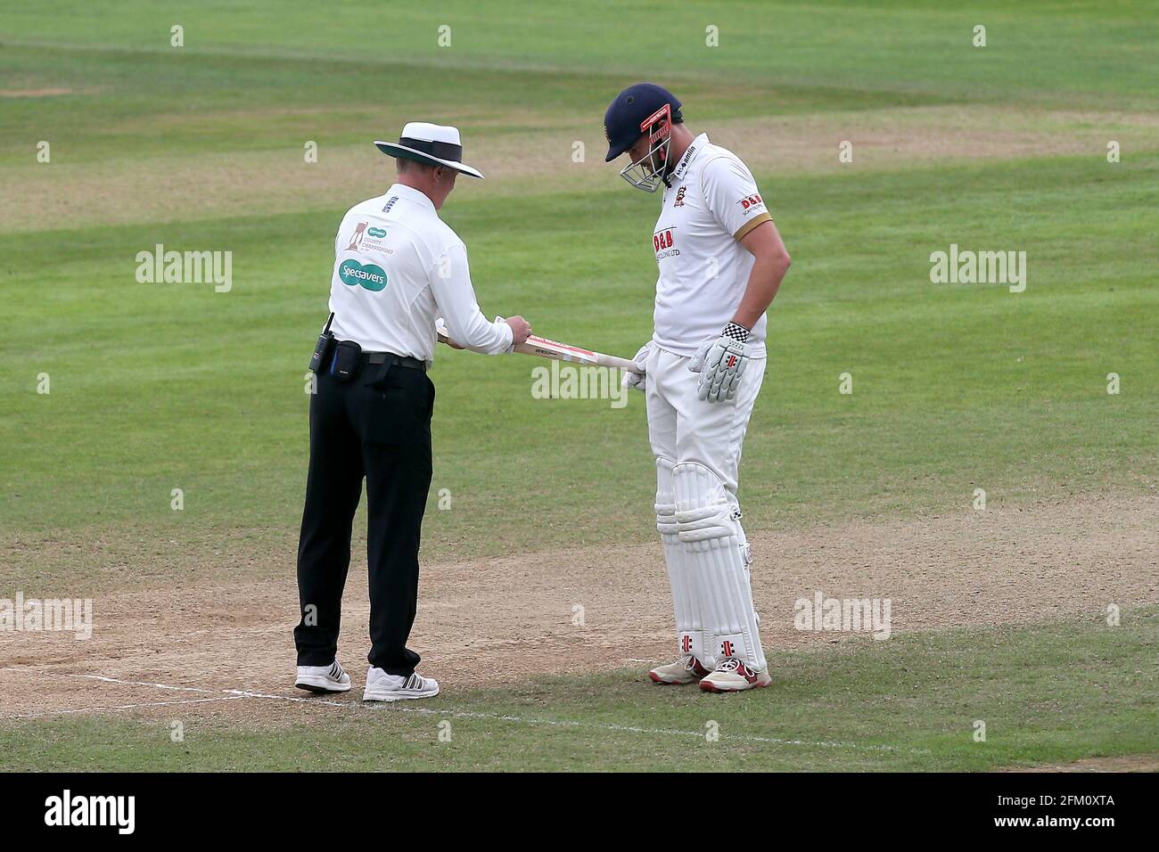 Umpire Ben Debenham checks Nick Browne's bat during Somerset CCC vs ...