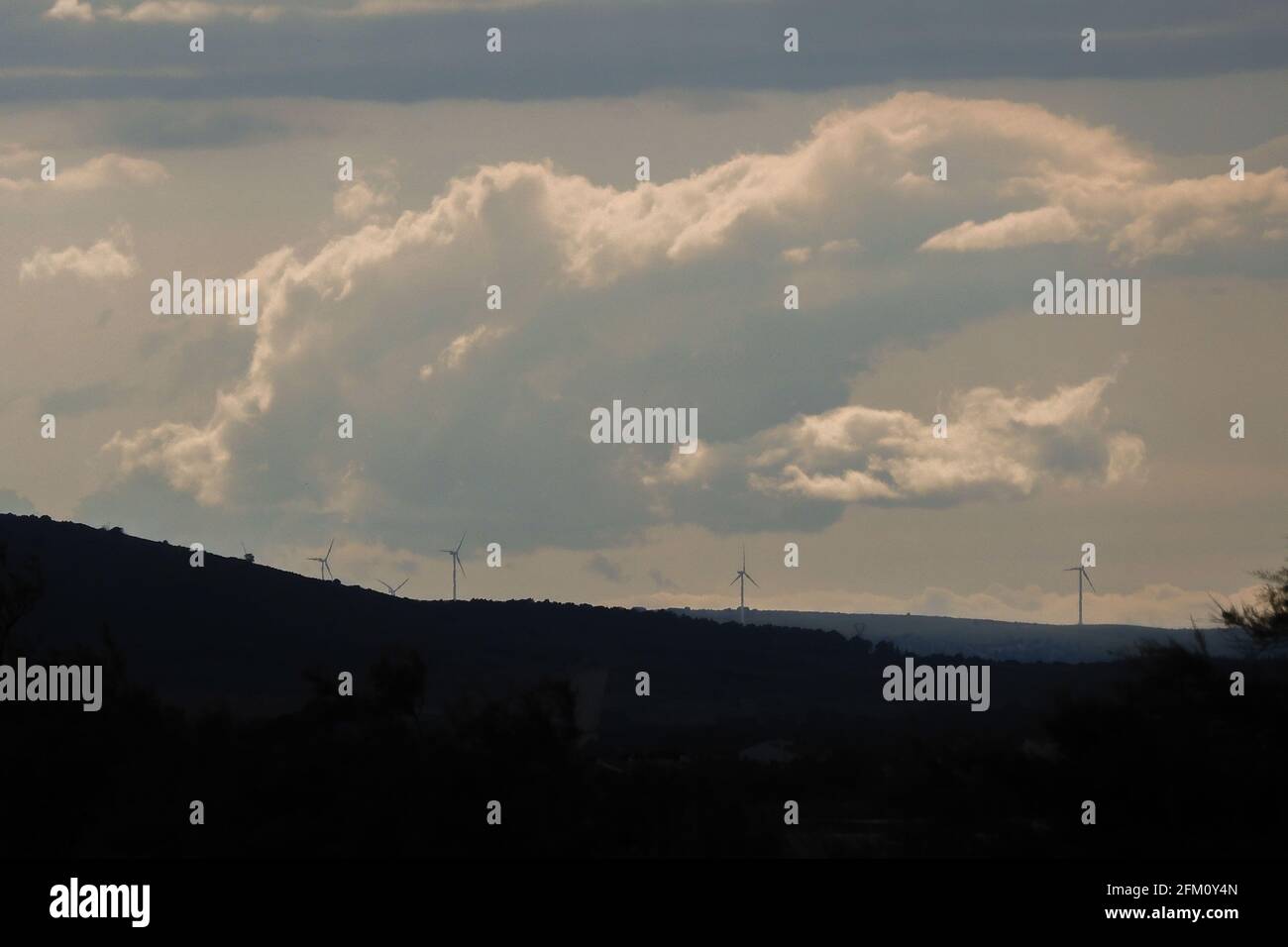 Wind turbines and clouds landscape sunset near Montpellier, Occitanie ...