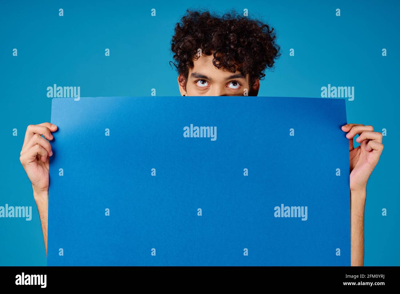 the guy with the blue poster advertising Copy Space Stock Photo - Alamy