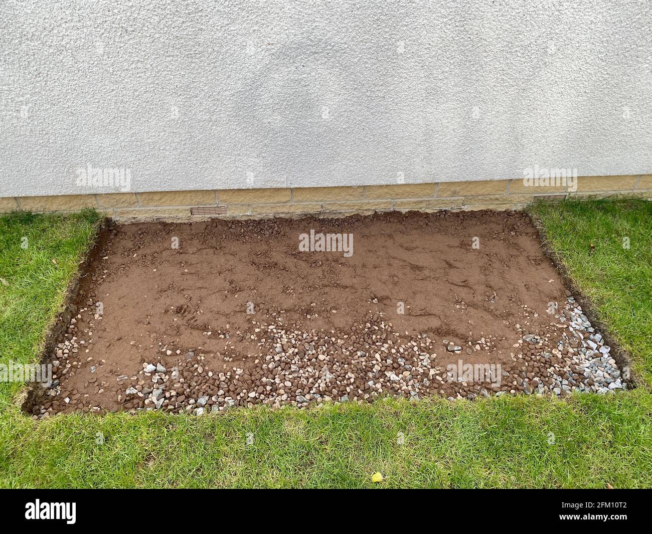 House garden grass turf cut for ground preparation to allow stone sub ...