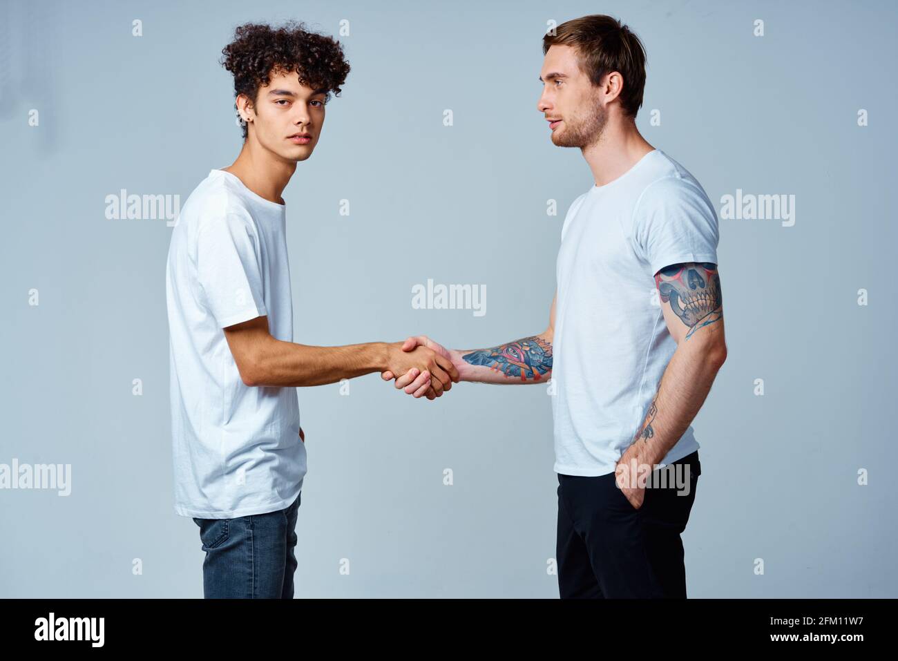 two men friendship shaking hands isolated background Stock Photo - Alamy