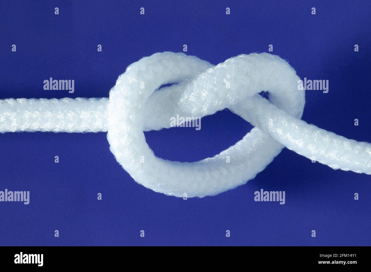 White rope knot in light blue background Stock Photo - Alamy
