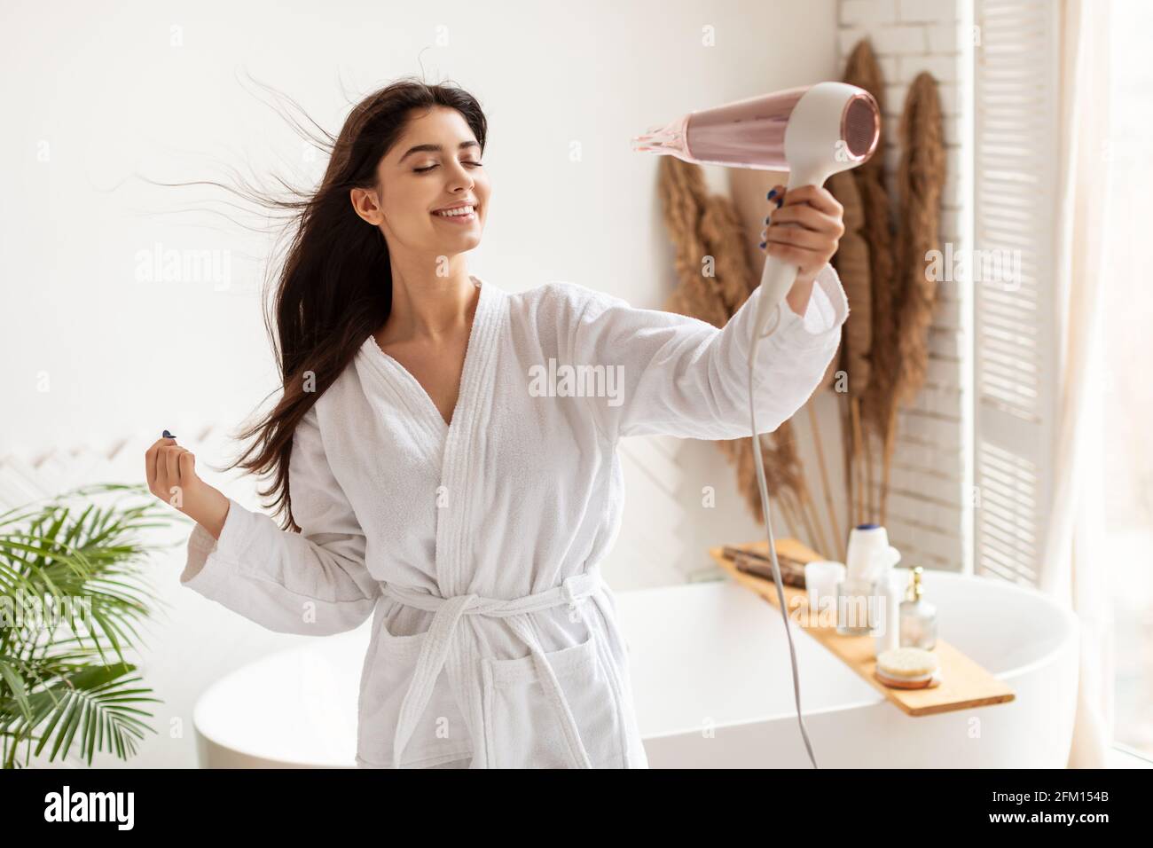 Joyful Lady Drying Hair Using Hairdryer Standing In Bathroom Stock ...