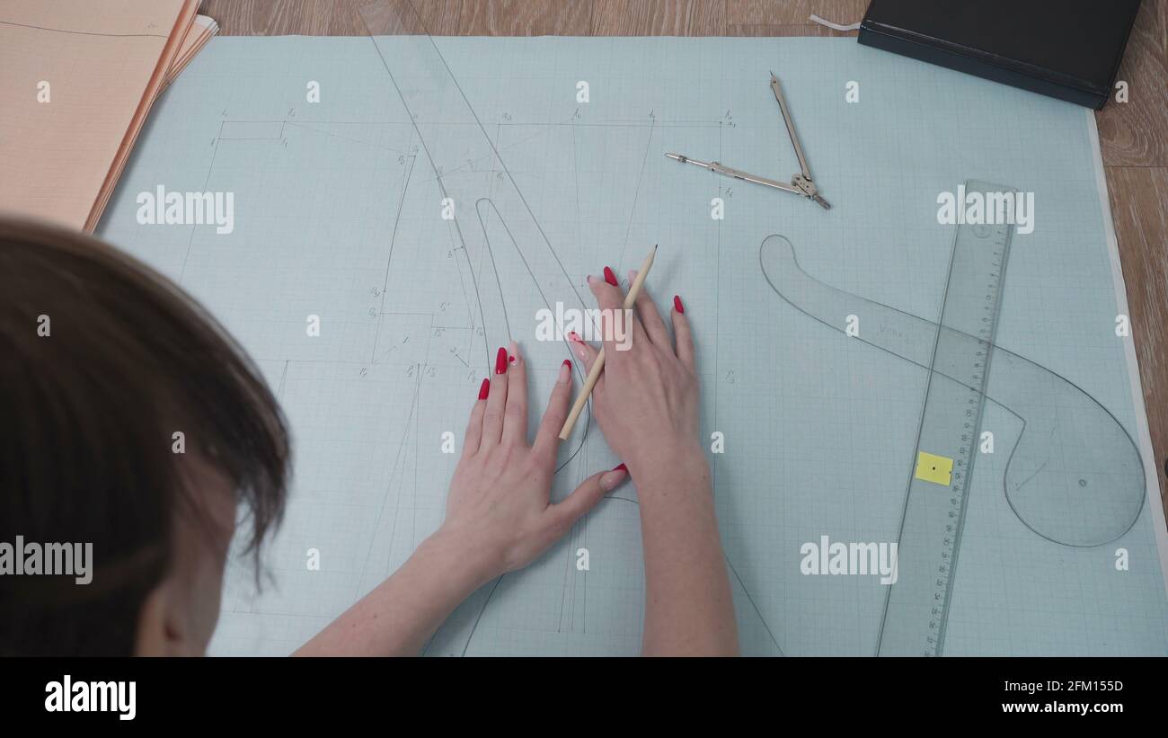 Photo of woman drawing curve in workshop Stock Photo - Alamy