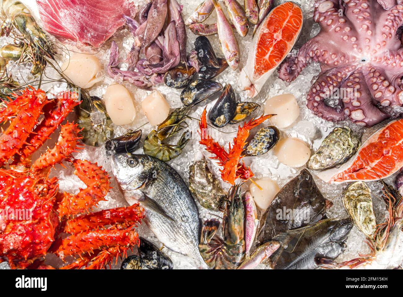 Set of various fresh raw seafood - octopus, crab, squid, shrimp prawn ...