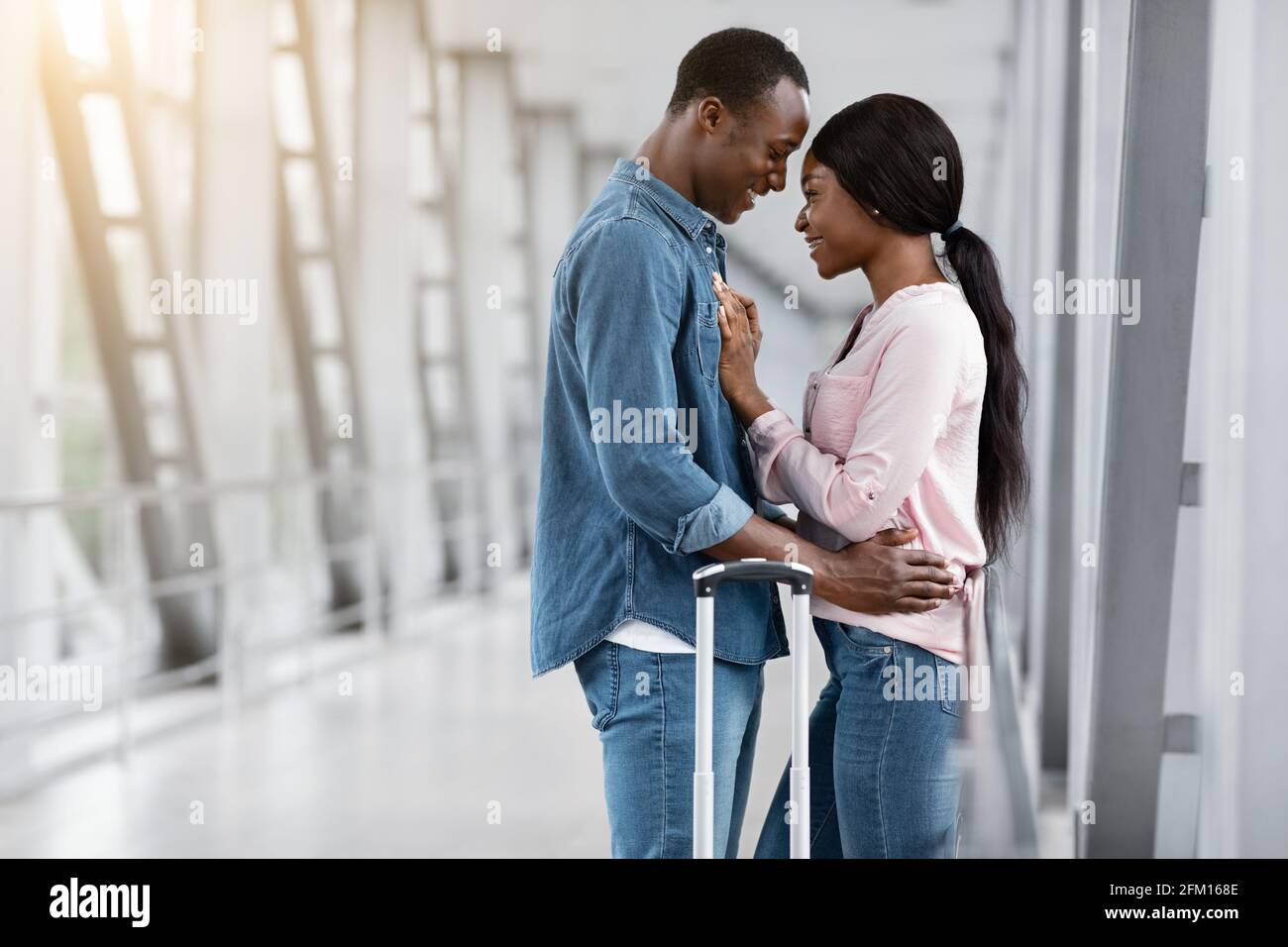 Portrait Of Romantic Black Couple Hugging In Airport Terminal, Waiting ...