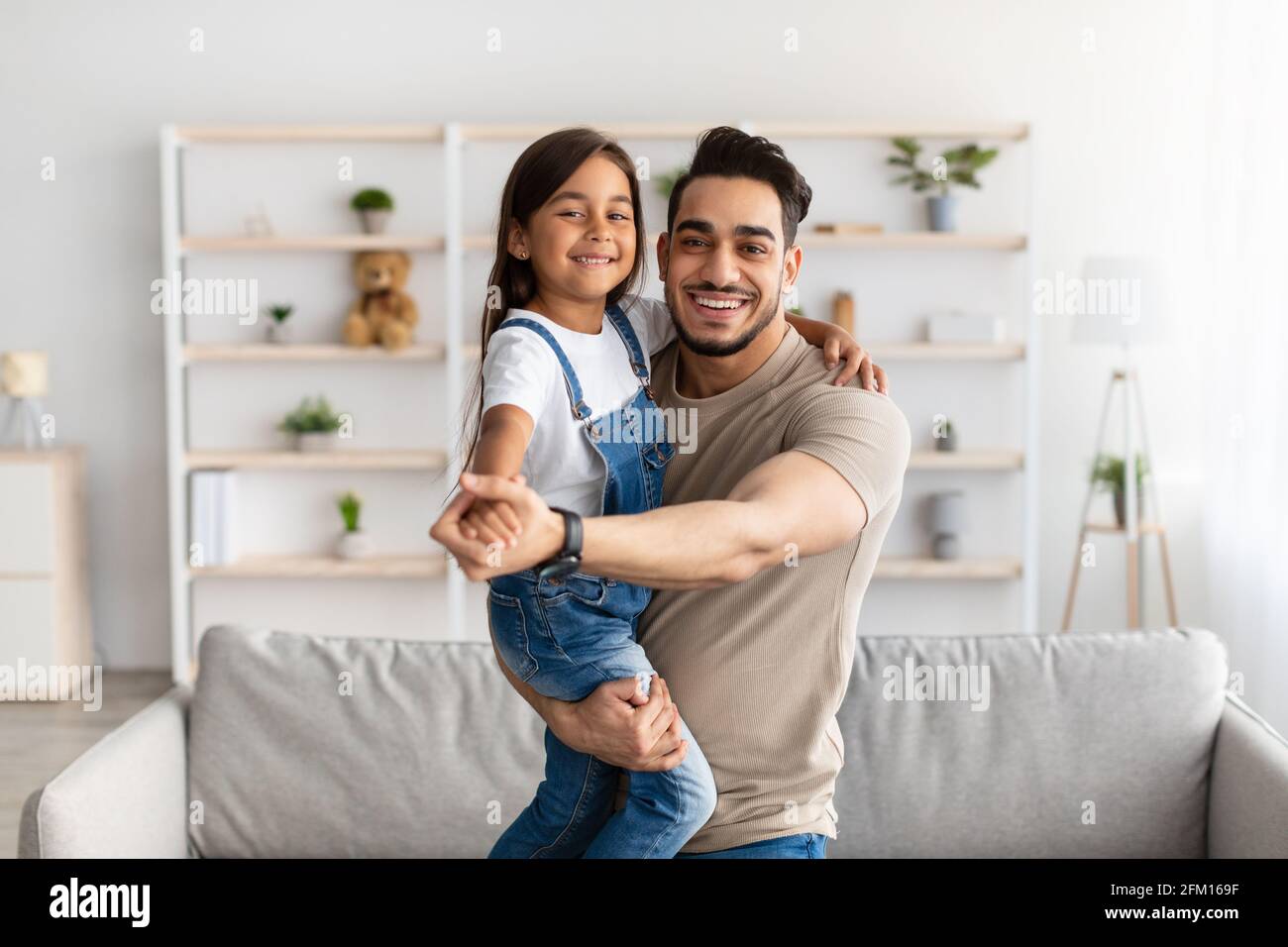 Dad and daughter dancing in living room together Stock Photo - Alamy