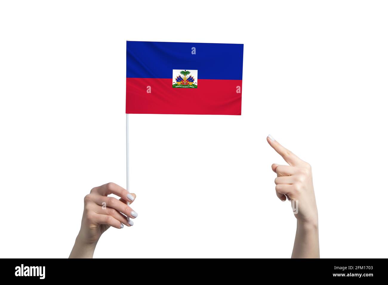A beautiful female hand holds a Haiti flag to which she shows the ...