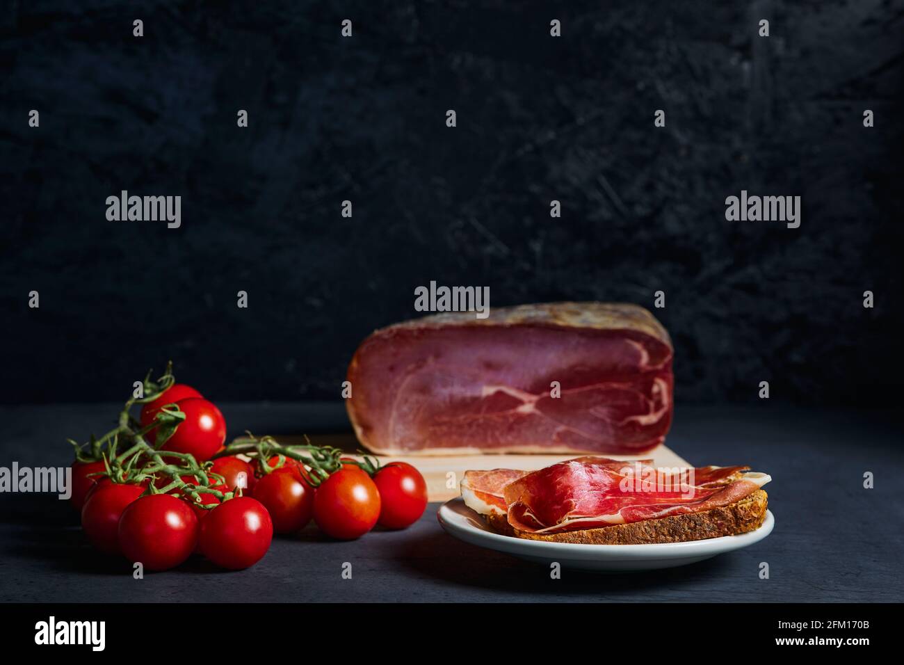 tapa of ham toast with tomatoes and olive oil. traditional Spanish and ...