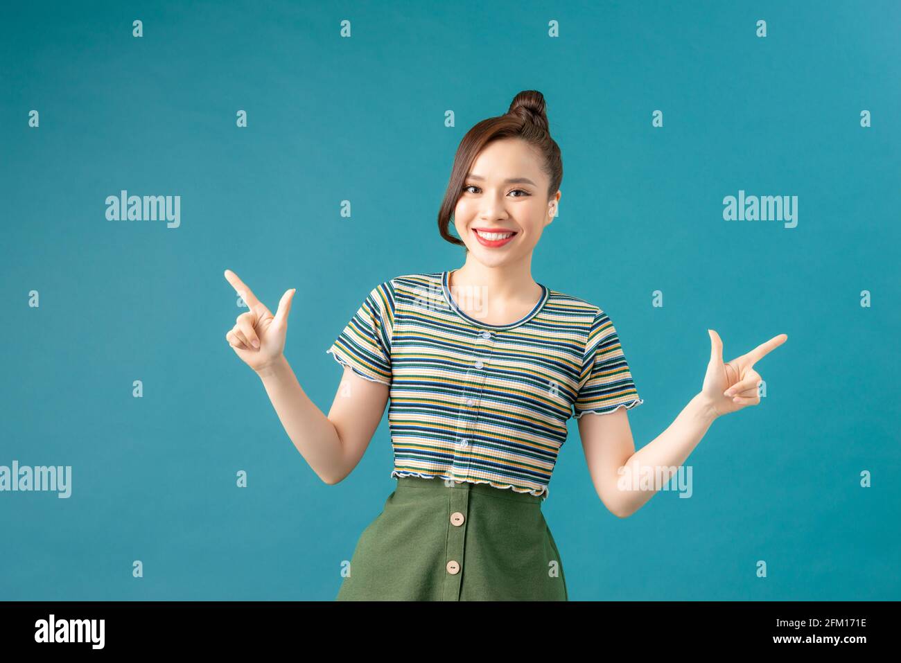 Woman pointing fingers left and right Stock Photo - Alamy