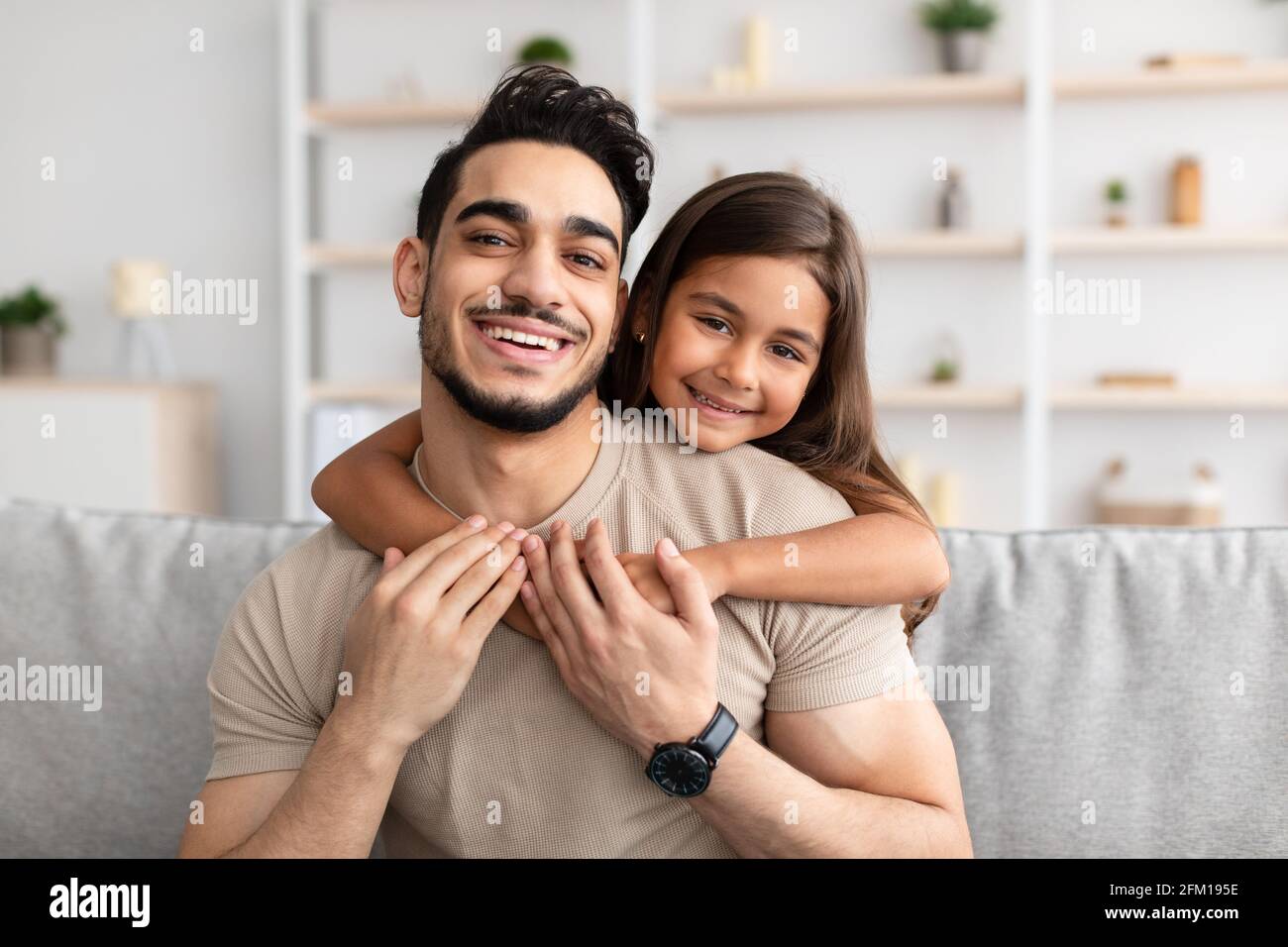 Portrait of father and daughter hugging at home Stock Photo - Alamy