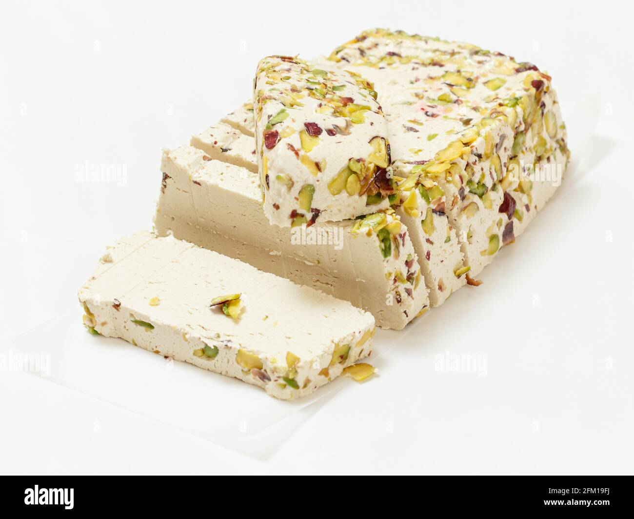 Halva with pistachios on a white piece of paper and background Stock ...
