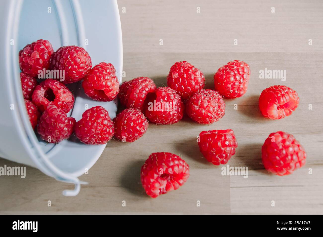 ripe and juicy raspberry in an inverted small bucket Stock Photo - Alamy