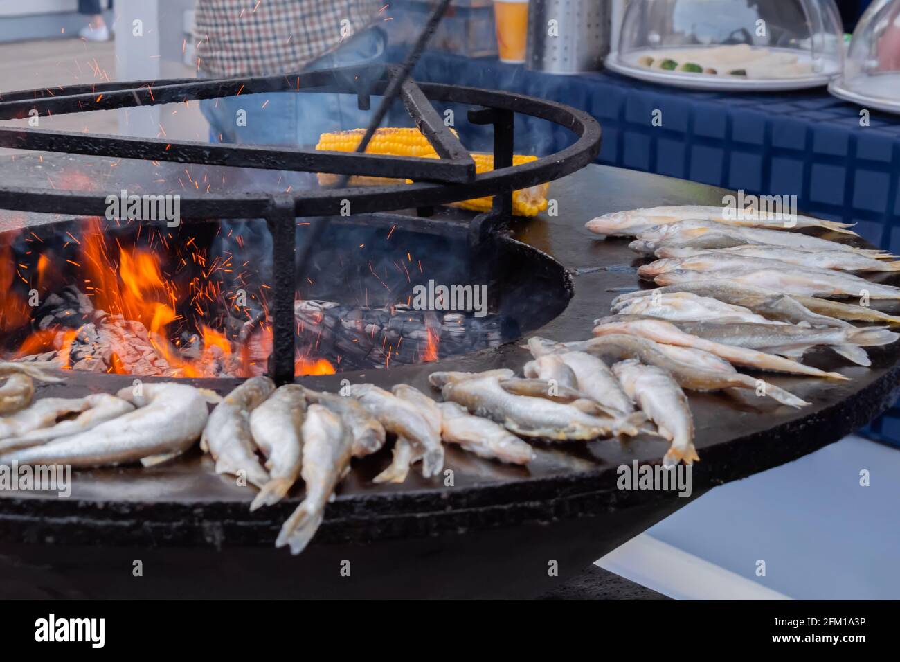 Process of cooking european smelt fish on black at food festival Stock ...