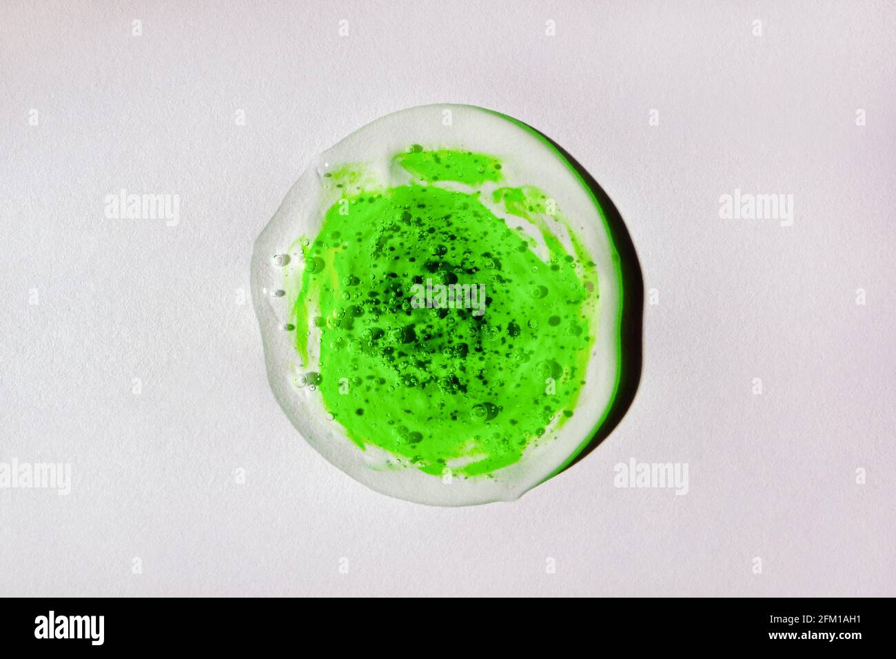 Green and white transparent gel drop isolated on white background. Top ...