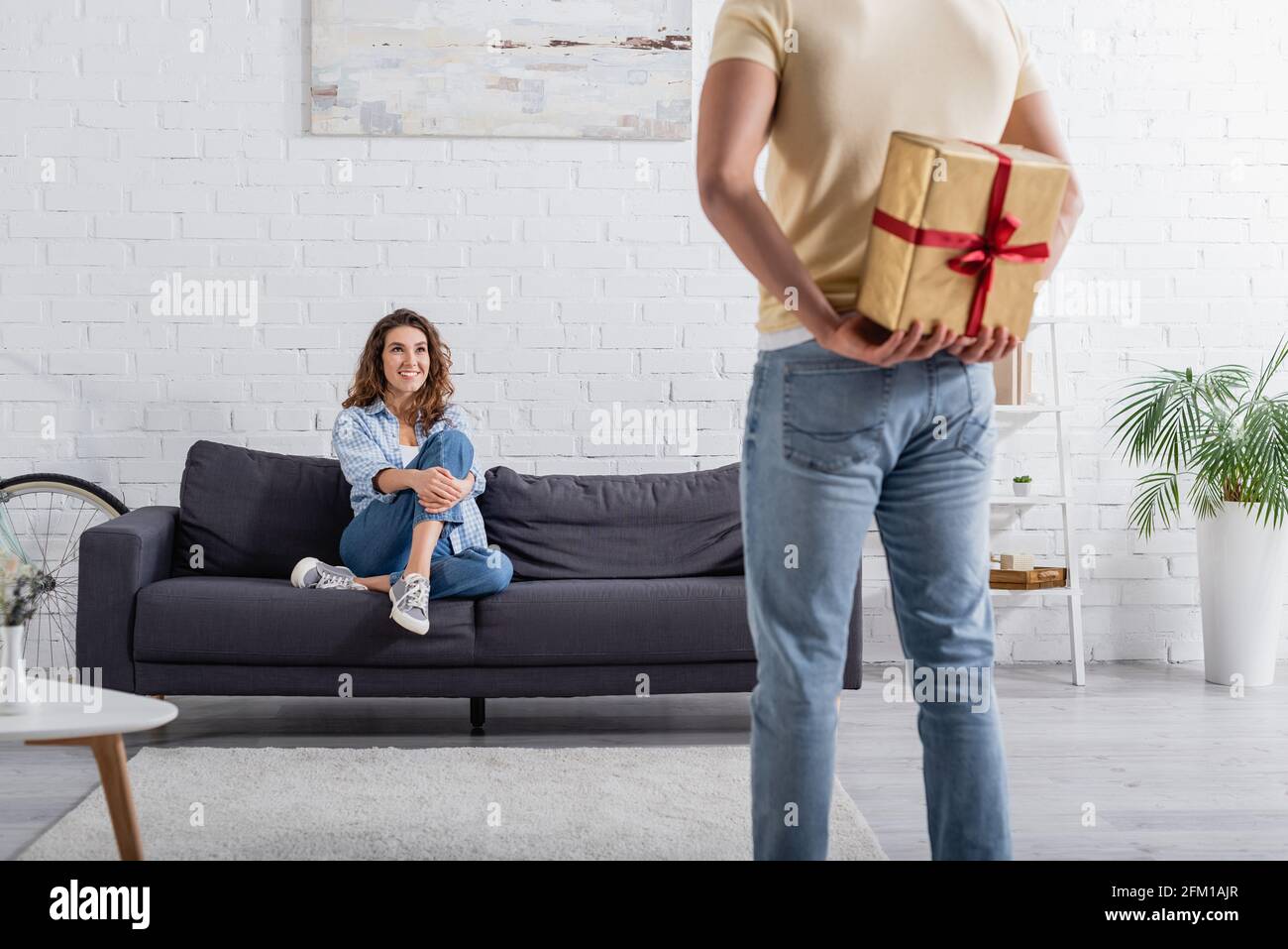 Happy young man back sofa hi-res stock photography and images - Alamy