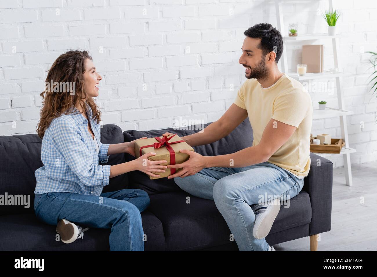 Arab man giving gift woman hi-res stock photography and images - Alamy