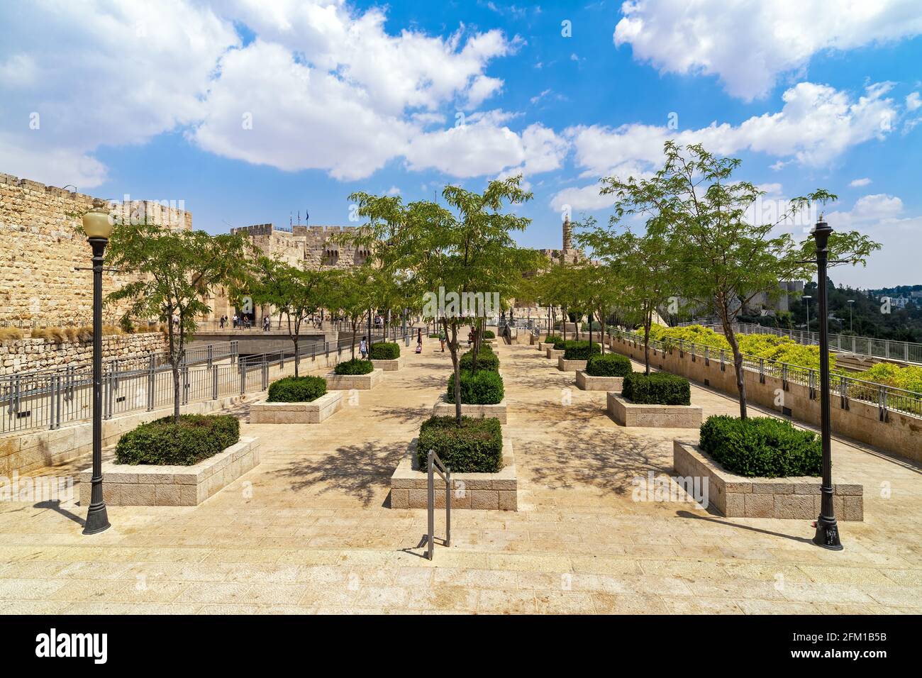 View of promenade with green trees and plants and ancient surrounding ...