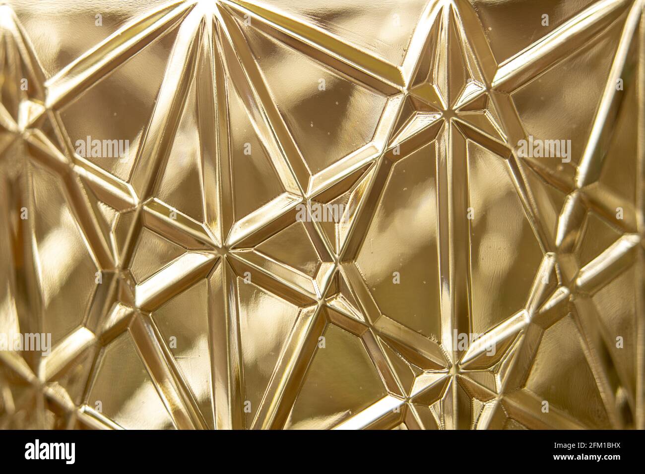 Closeup of the triangle-shaped patterns on the golden plastic surface ...