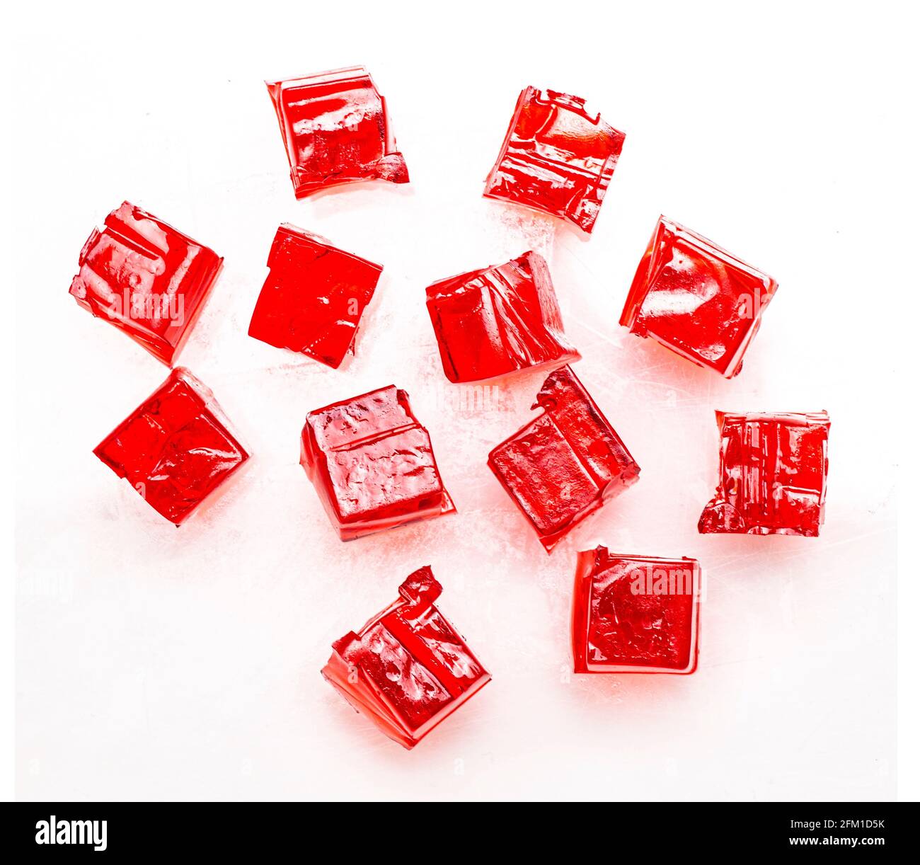 Red Jelly cubes on a white background Stock Photo - Alamy