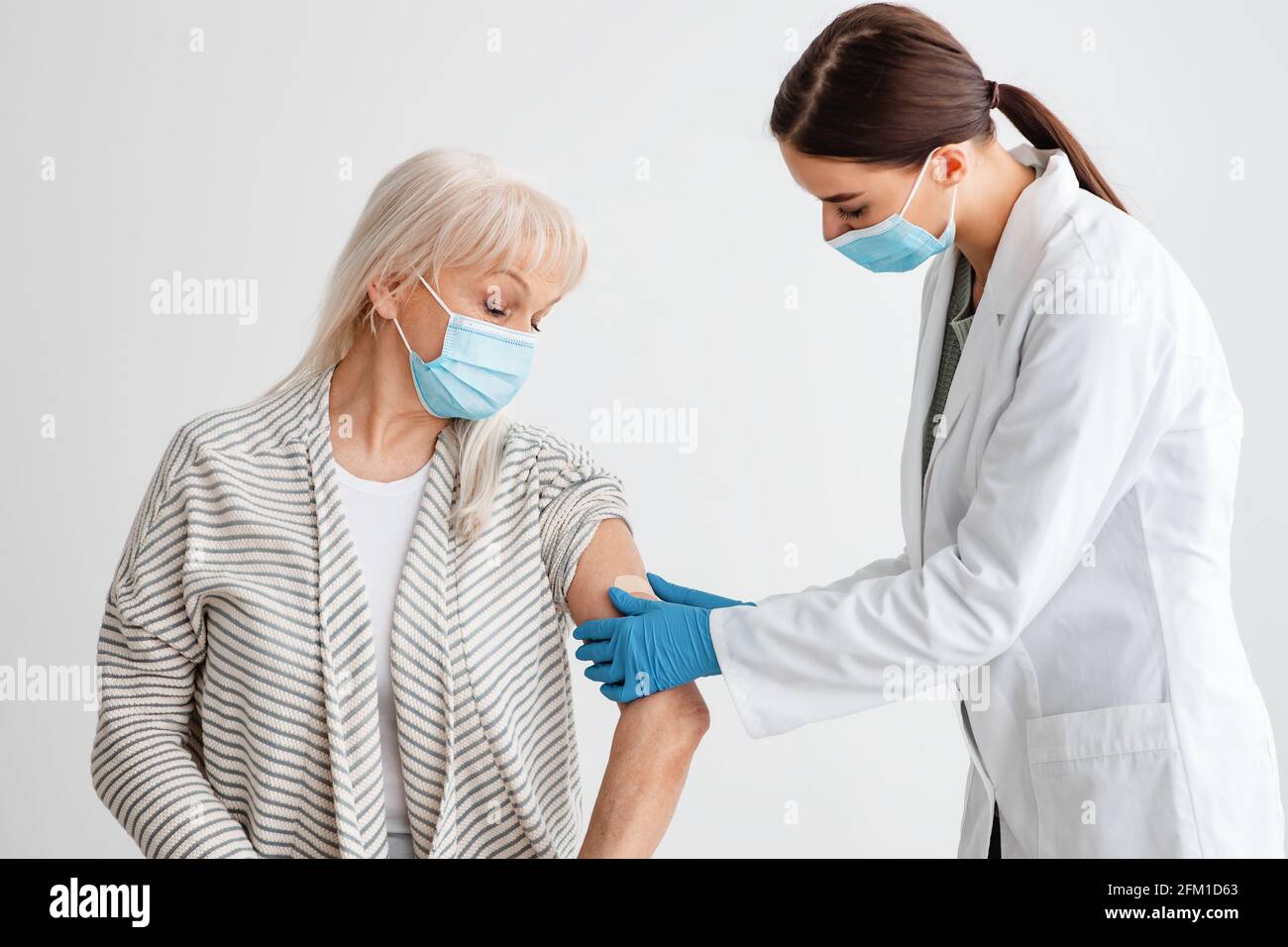 Senior Woman Receiving Coronavirus Vaccine Intramuscular Injection ...