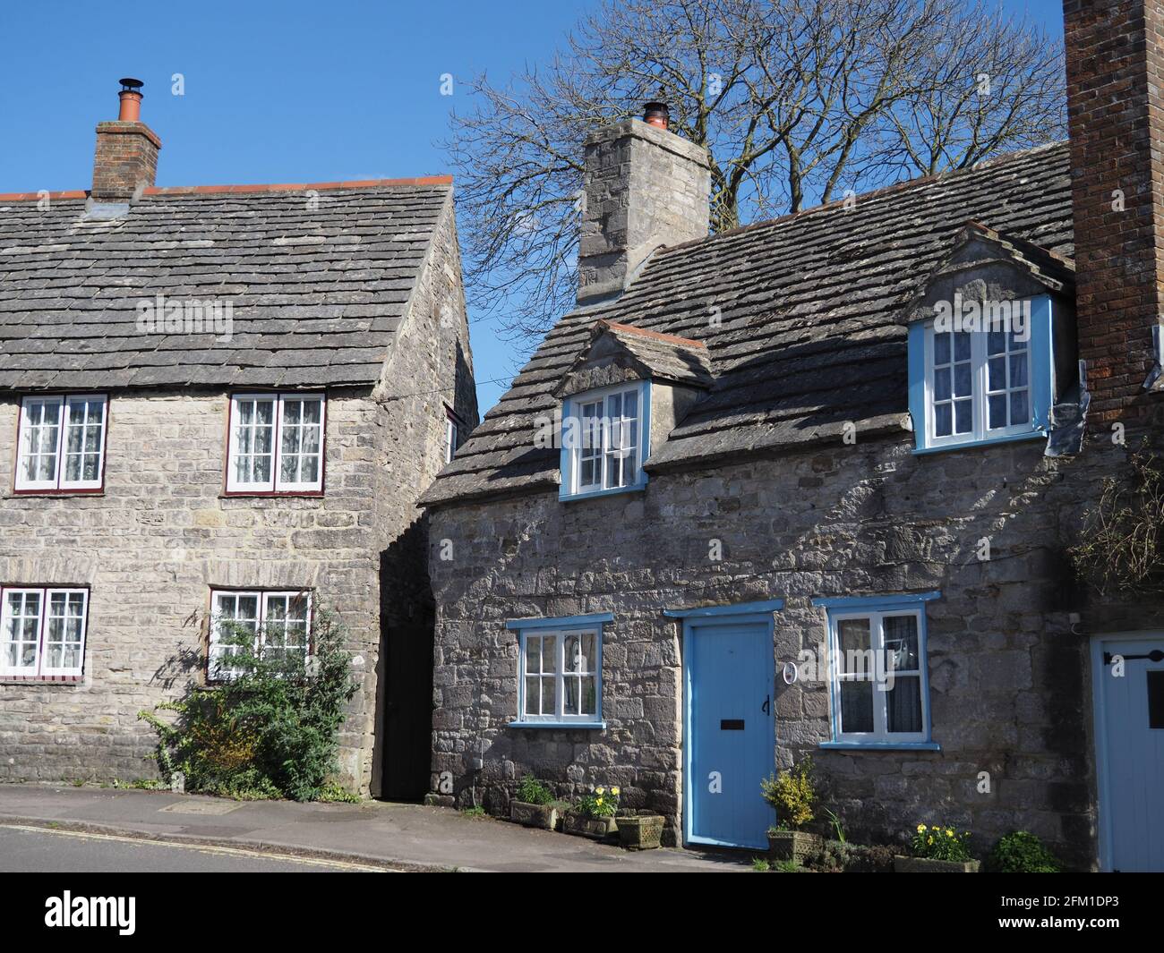 an elegant old stone cottage with a light blue door Stock Photo - Alamy