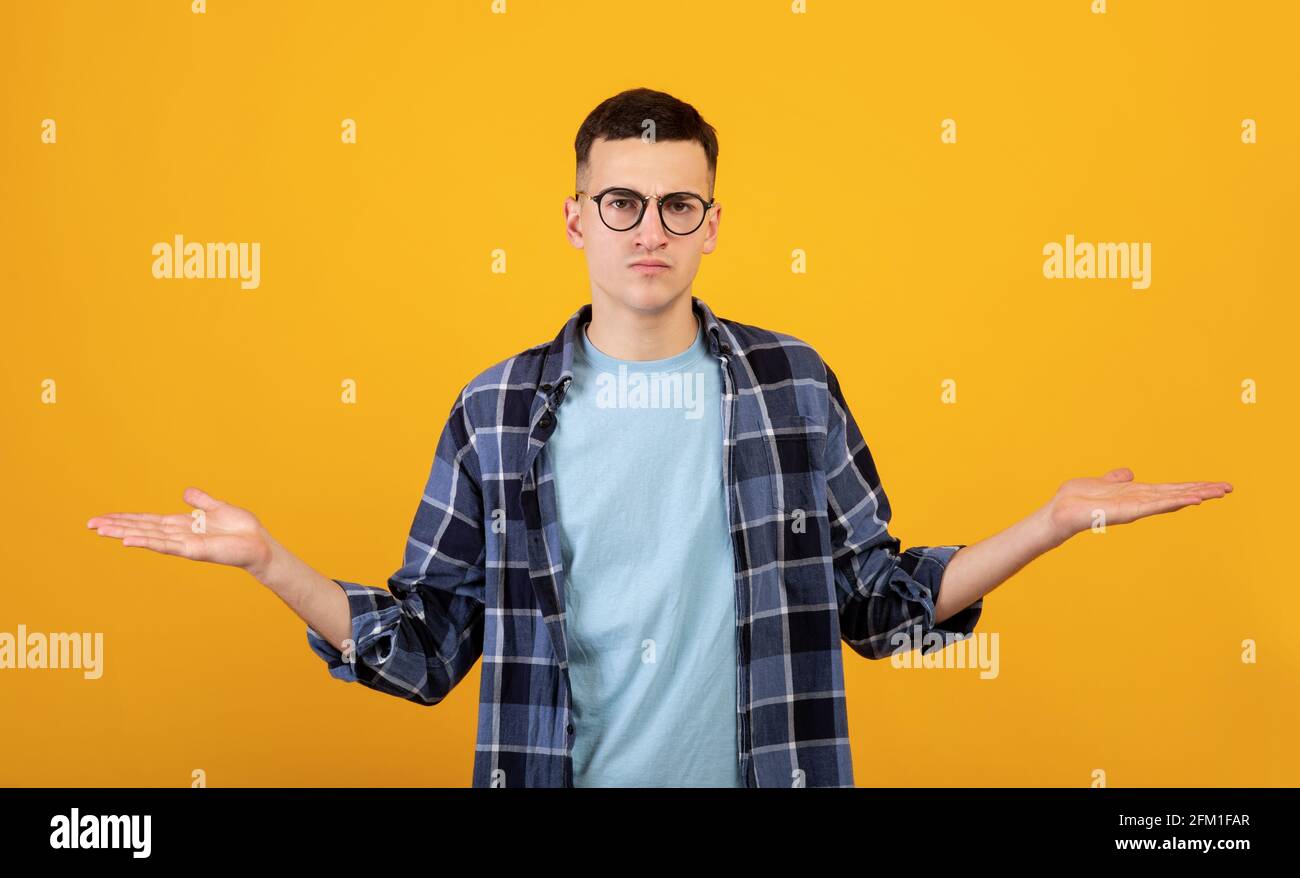 Irritated Caucasian man comparing variants, making scale with his empty ...