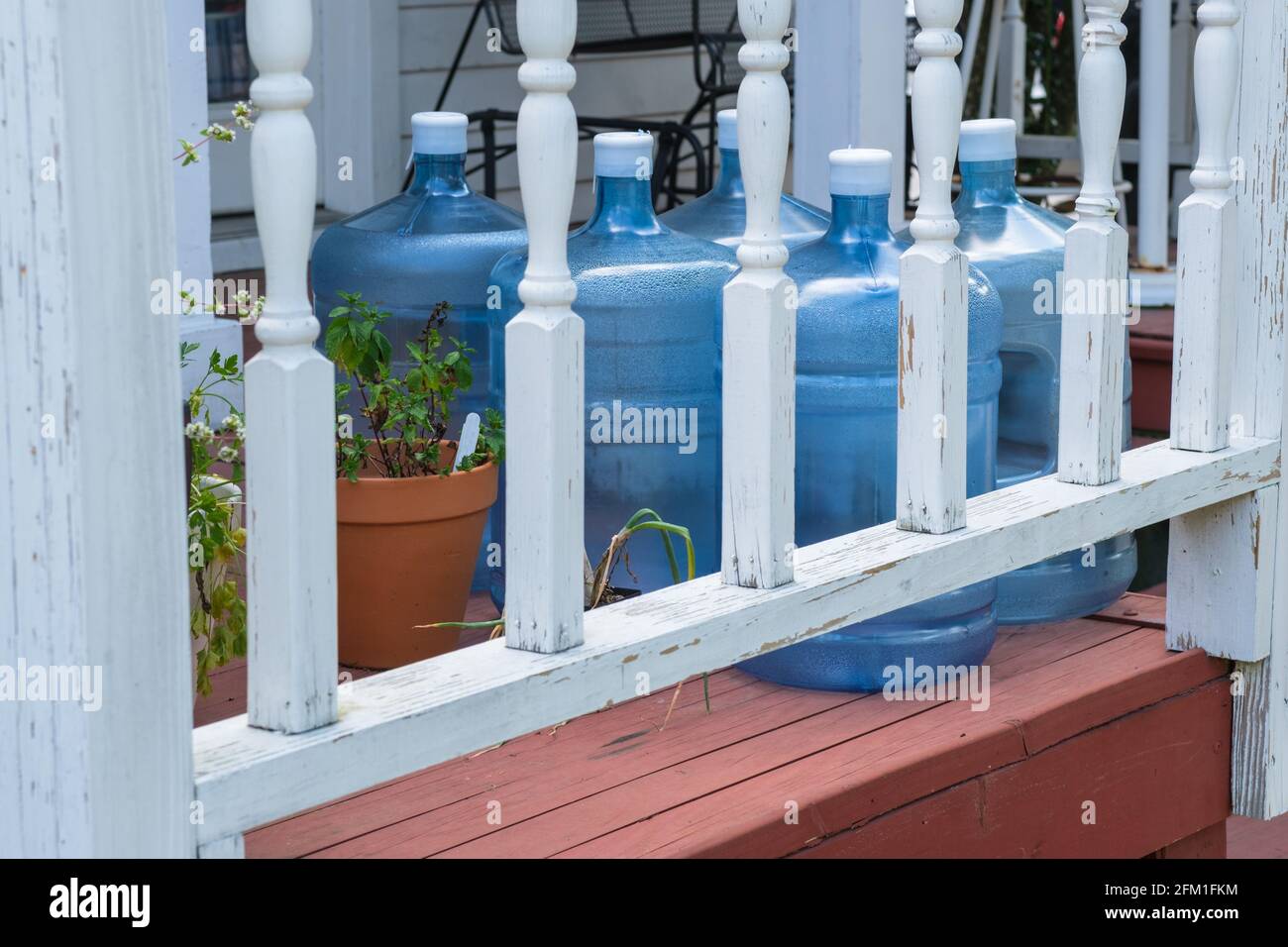 Full water bottles on the front porch Stock Photo - Alamy
