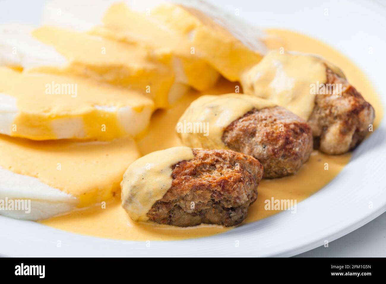 minced meat ball with creamy sauce and dumplings Stock Photo - Alamy