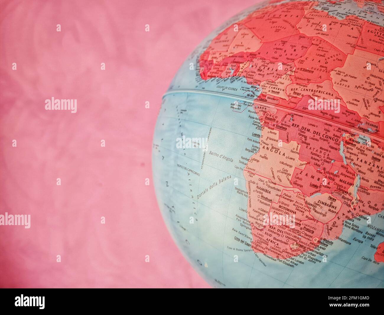 Revolving world map on a pink background Stock Photo - Alamy