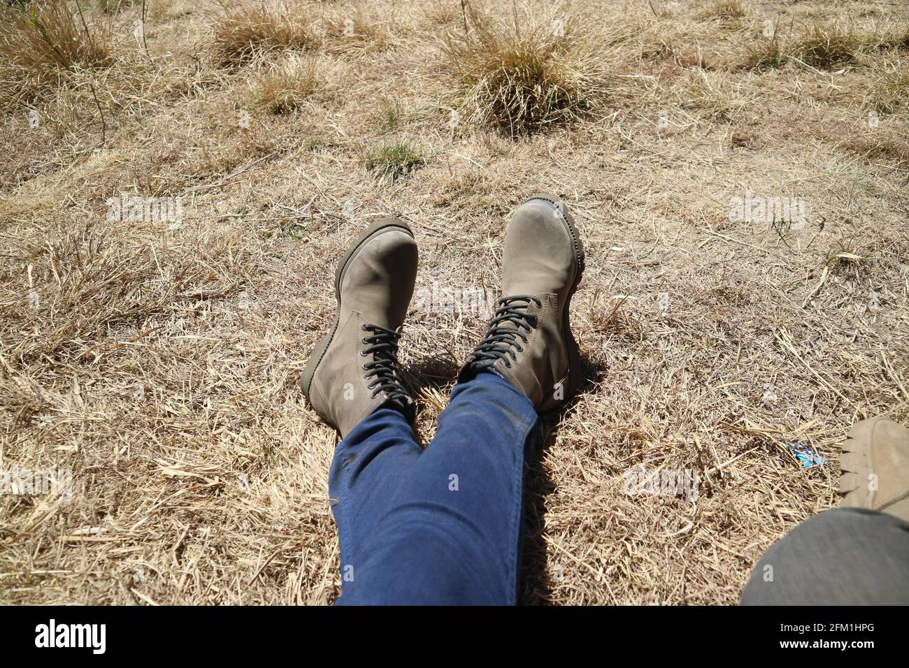 someone's feet wearing brown boots photo Stock Photo - Alamy
