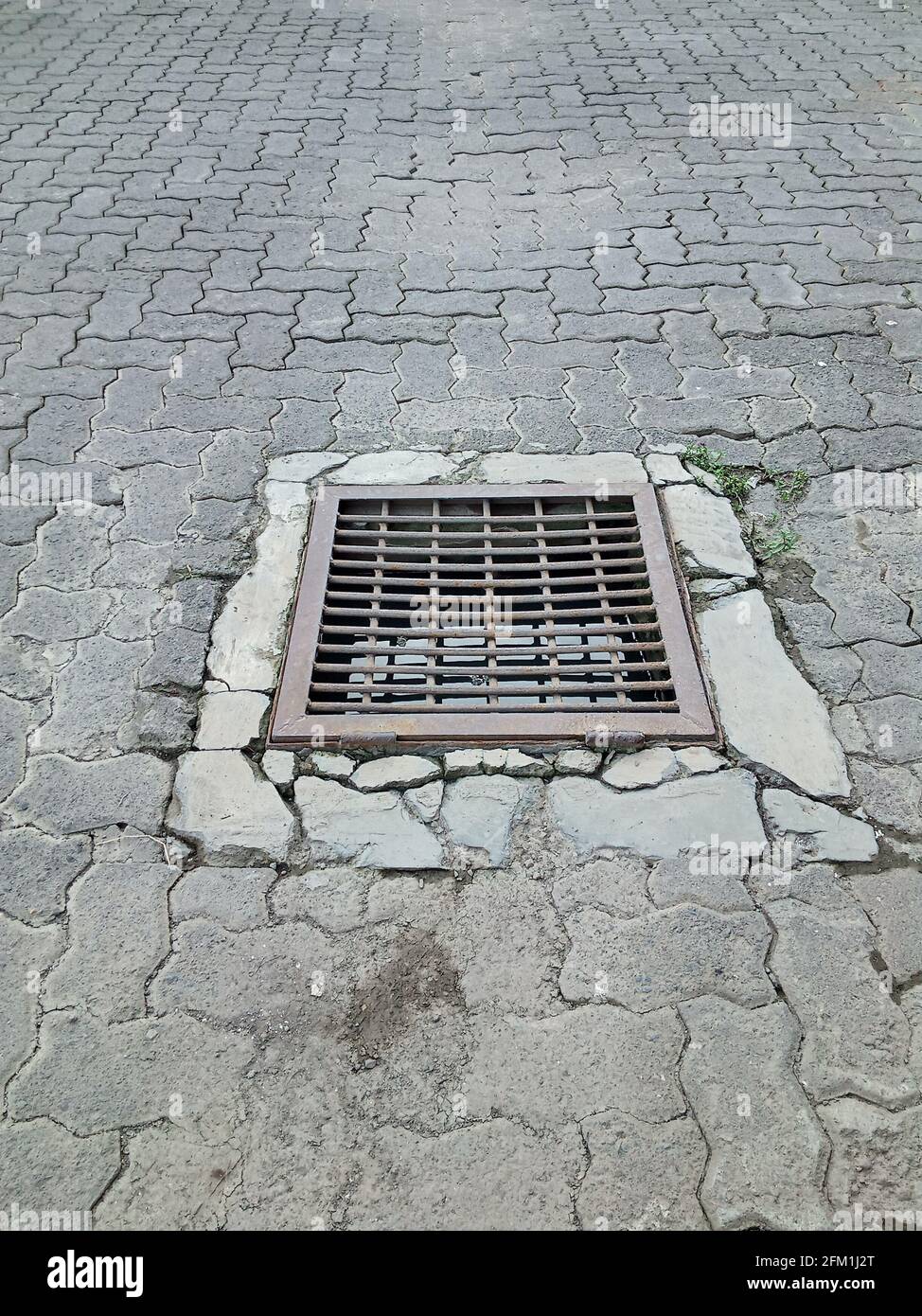 iron hole drains by the side of the road photo Stock Photo - Alamy