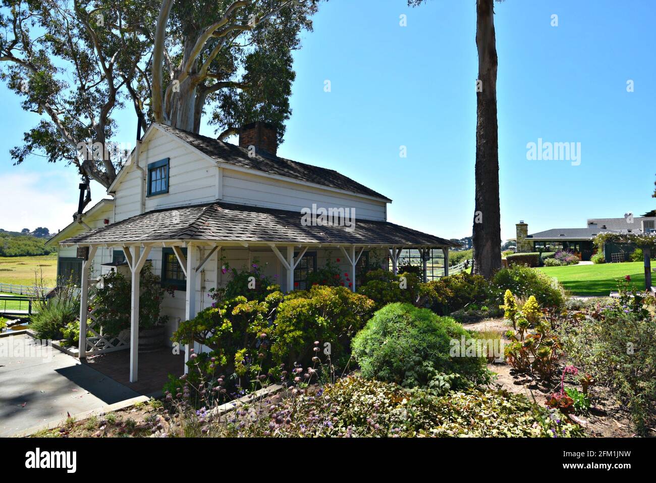 Landscape with a Normandy Revival style cottage in the countryside of ...