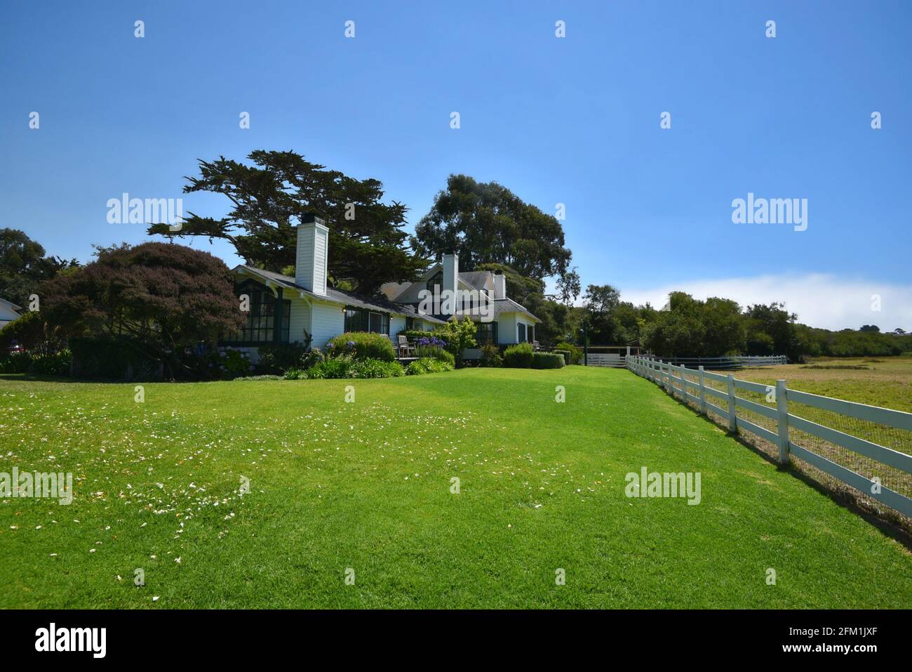 Landscape with a Normandy Revival style cottage in the countryside of ...