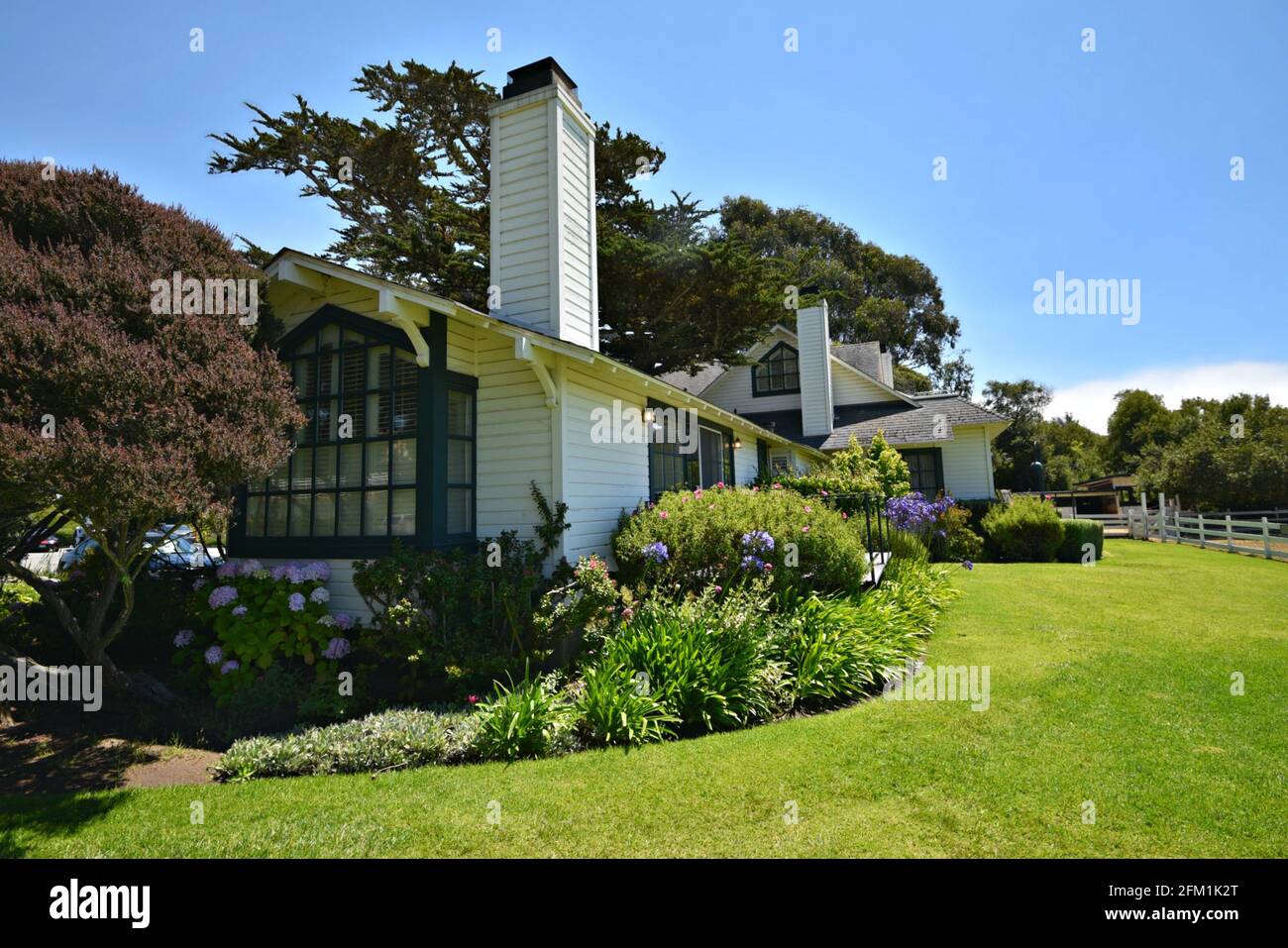 Landscape with a Normandy Revival style cottage in the countryside of ...