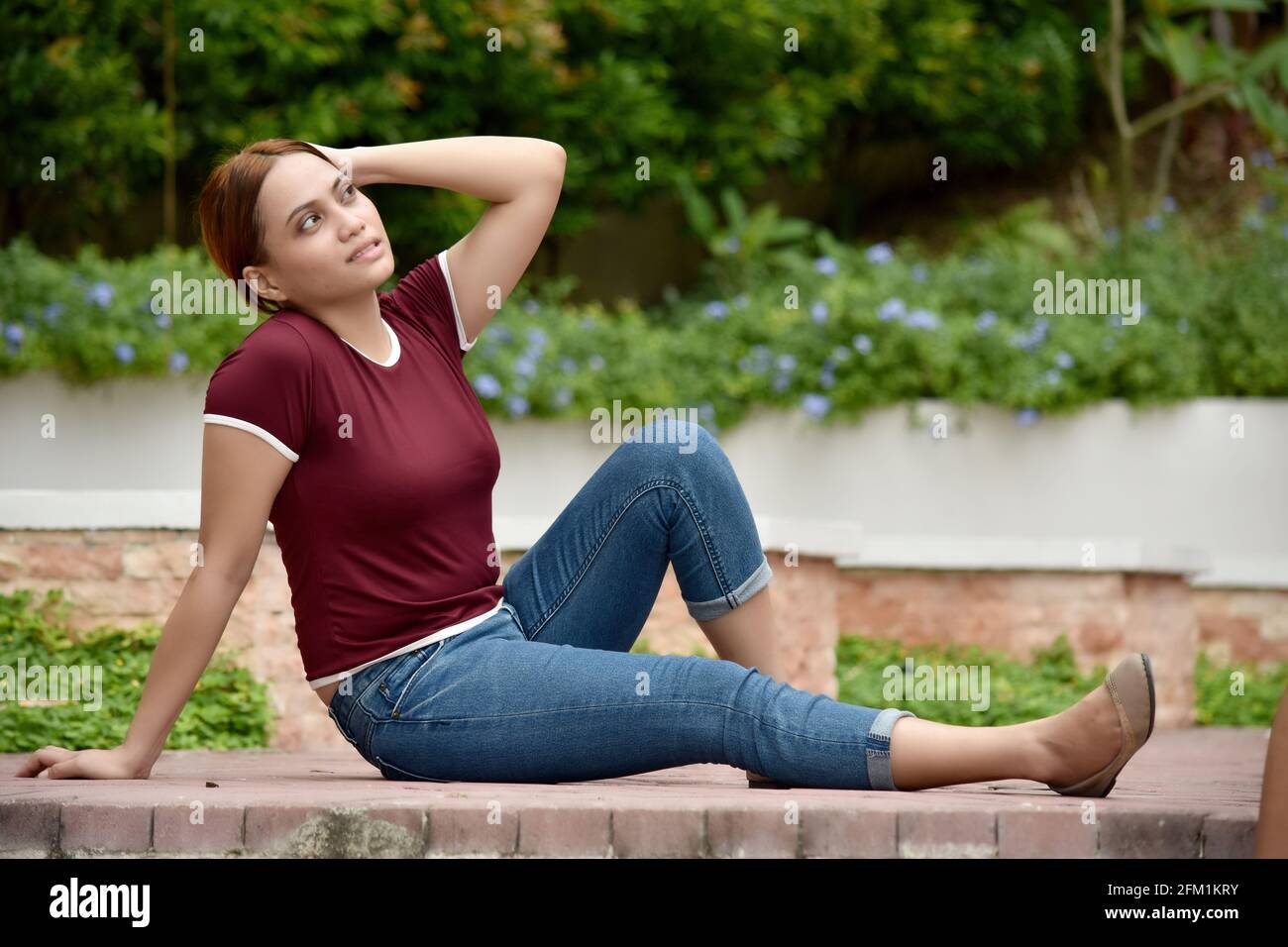 A Contemplative Attractive Female Woman Sitting Stock Photo - Alamy