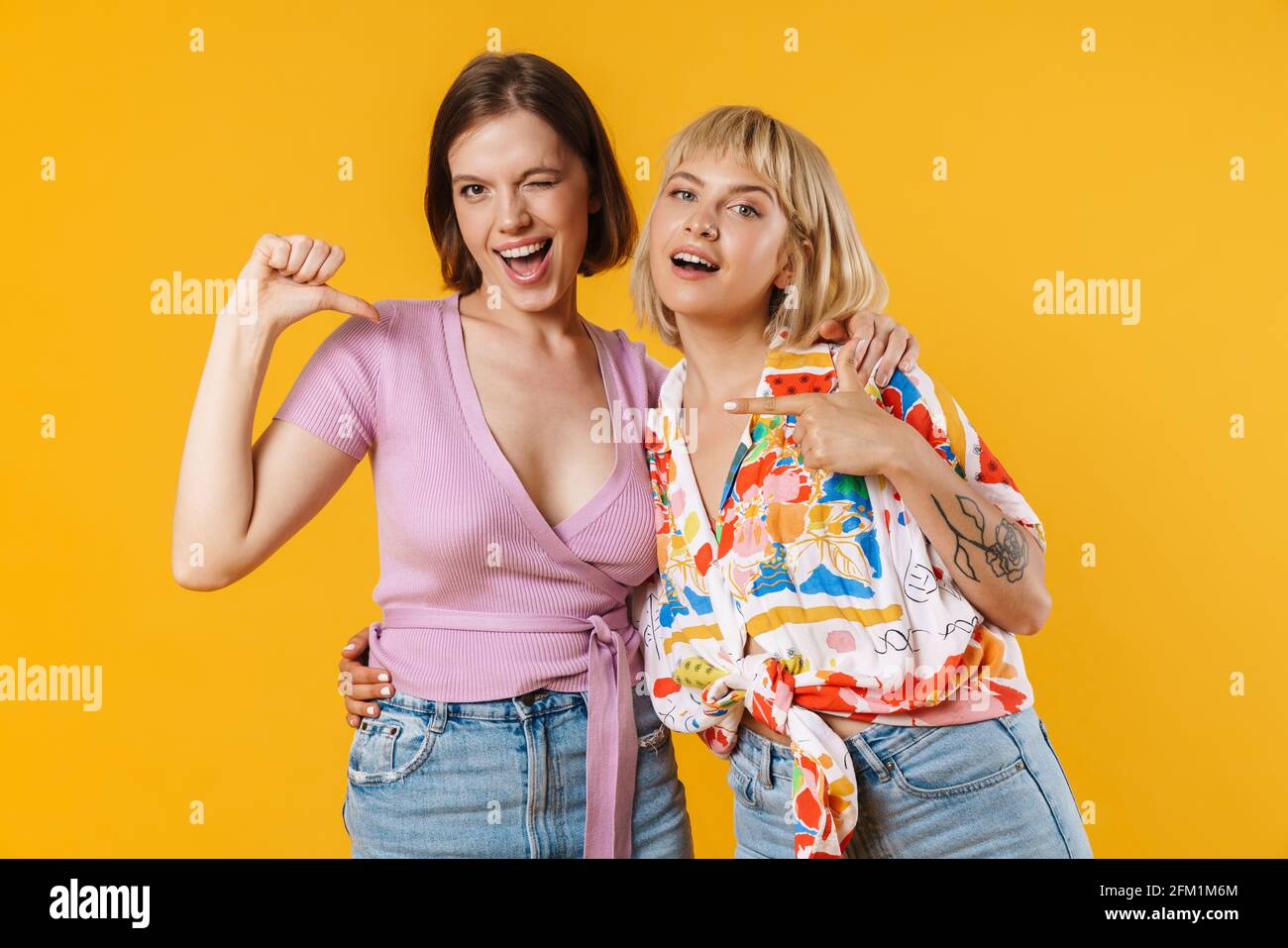 Portrait of two cheerful lovely girlfriends wearing summer clothes ...