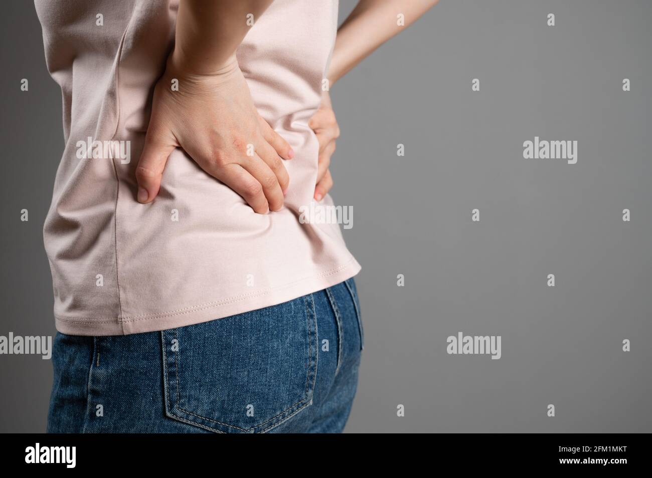 The woman has a pain in the lower back Stock Photo - Alamy