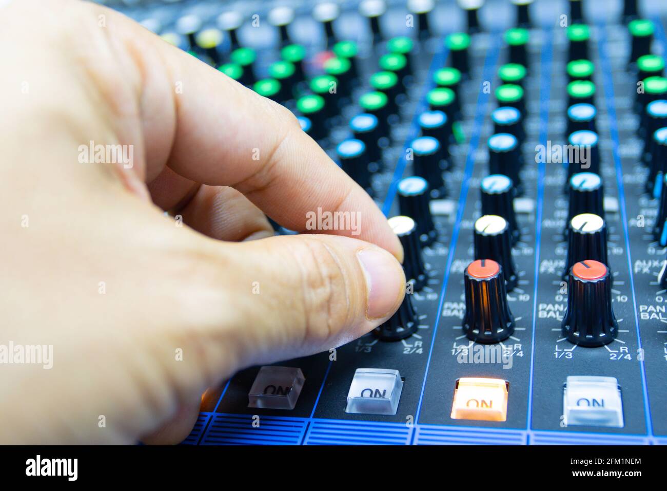 hands of Men are controlling the console of a large hi-fi system. Sound ...