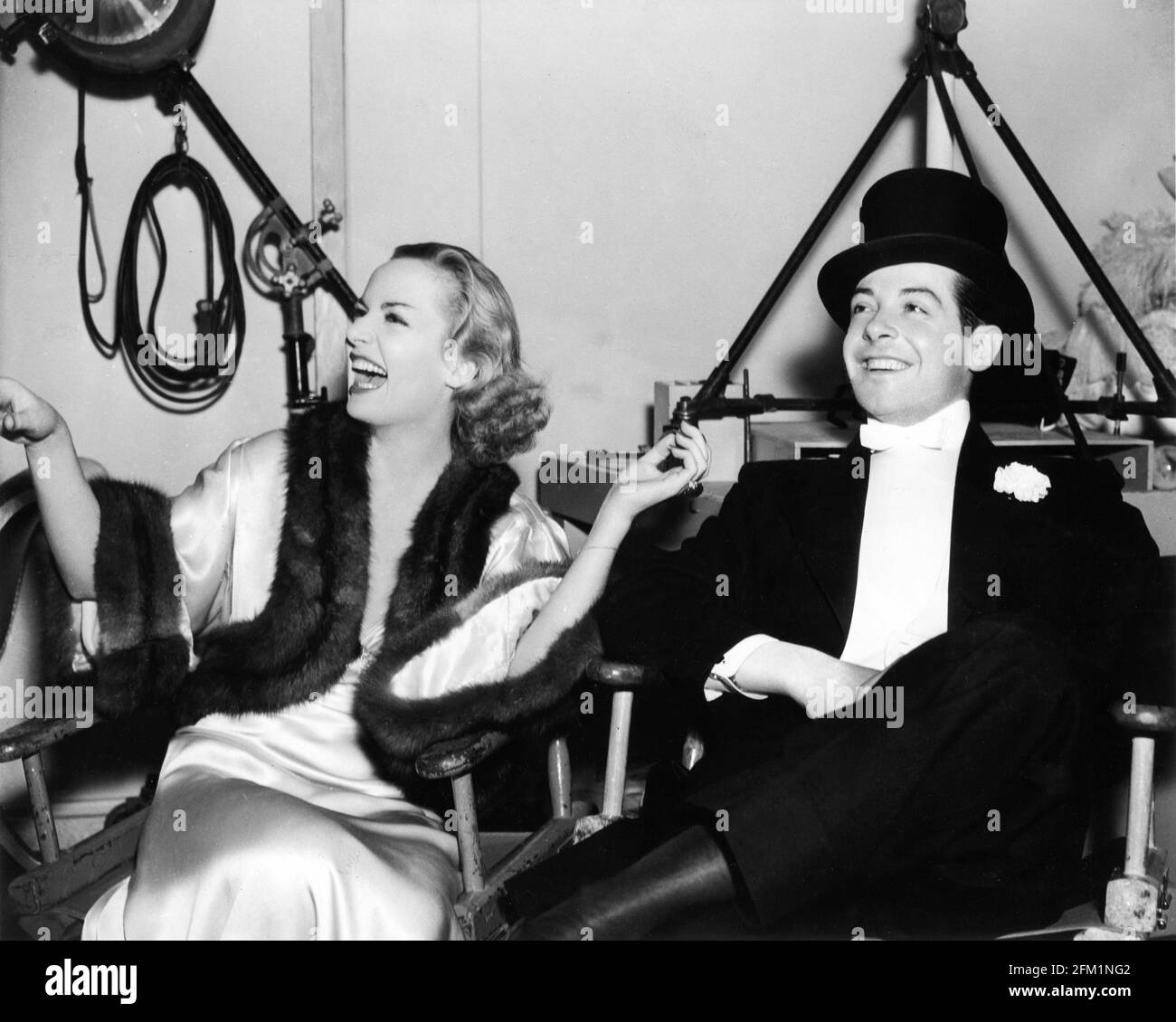 CAROLE LOMBARD and FERNAND GRAVET on set candid relaxing between takes ...