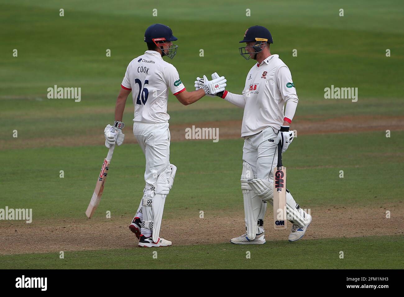 Tom Westley of Essex congratulates Alastair Cook (L) on reaching his ...