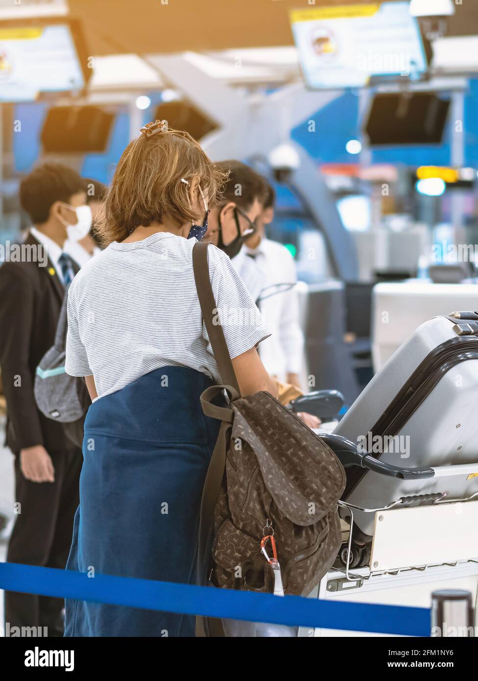 Back view of airline passenger wear face mask to prevent Corona virus ...