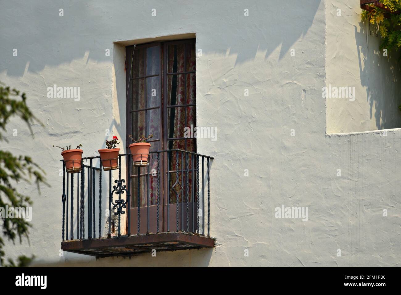 Spanish Colonial hacienda balcony with a handcrafted iron railing and ...