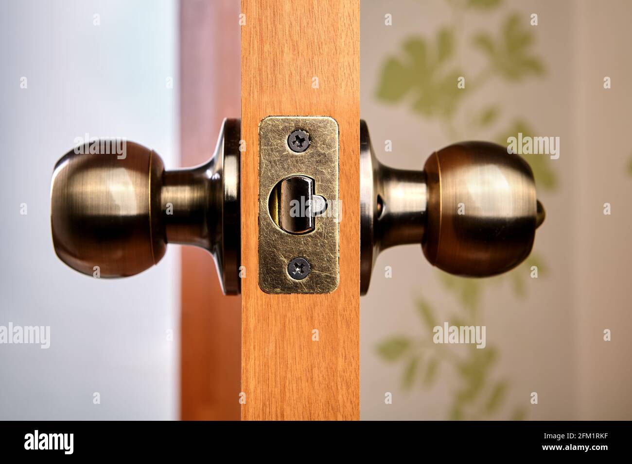 Door handles with latch, ball-shaped, bronze color Stock Photo - Alamy