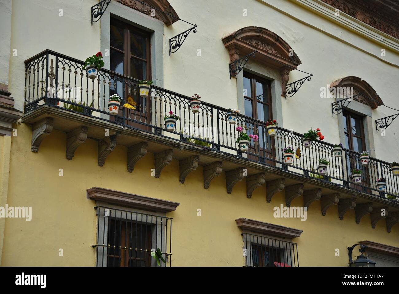 Spanish Colonial building facade with a Venetian stucco wall, wooden ...