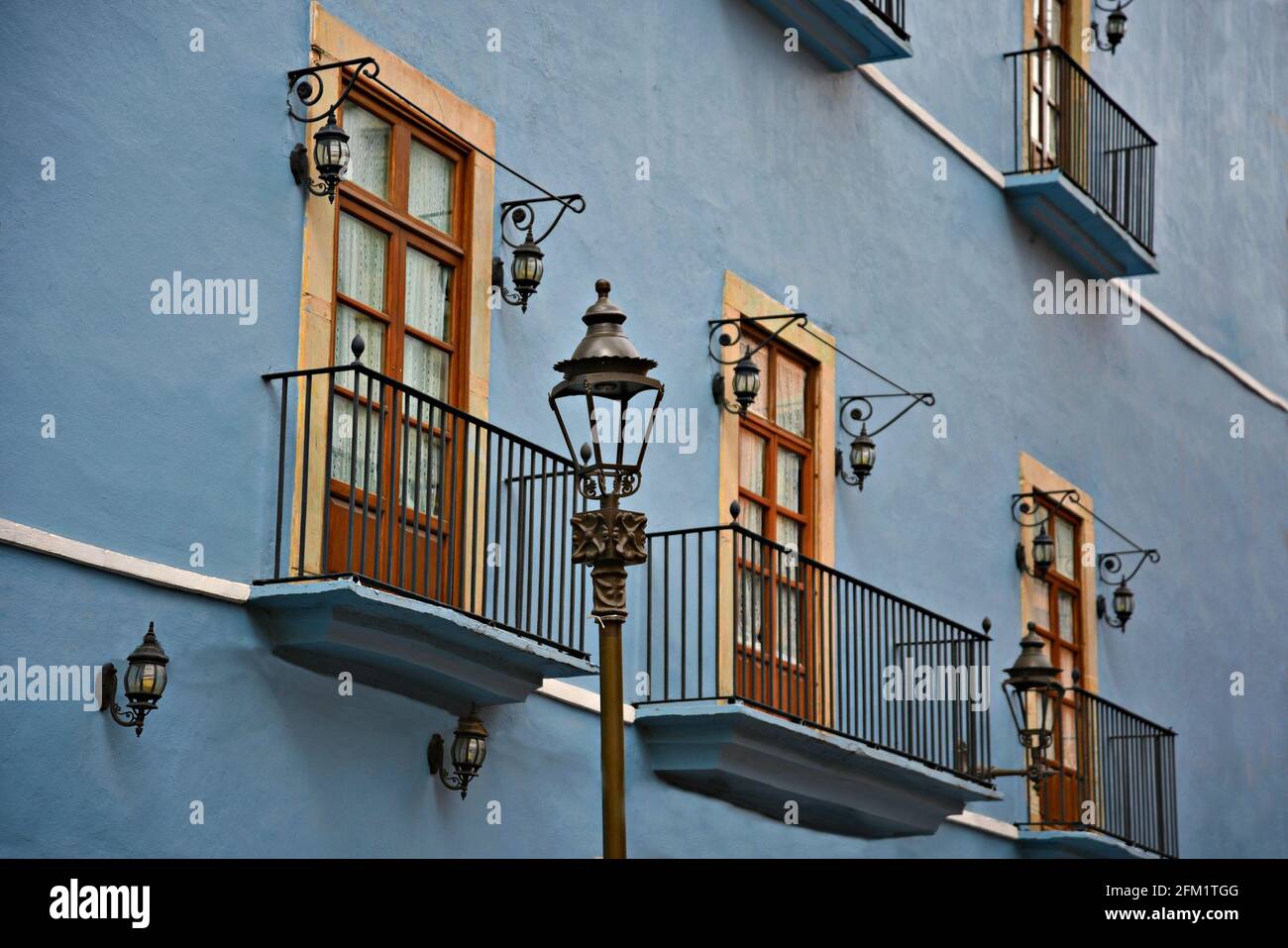 Spanish Colonial building facade with a light blue Venetian stucco wall ...