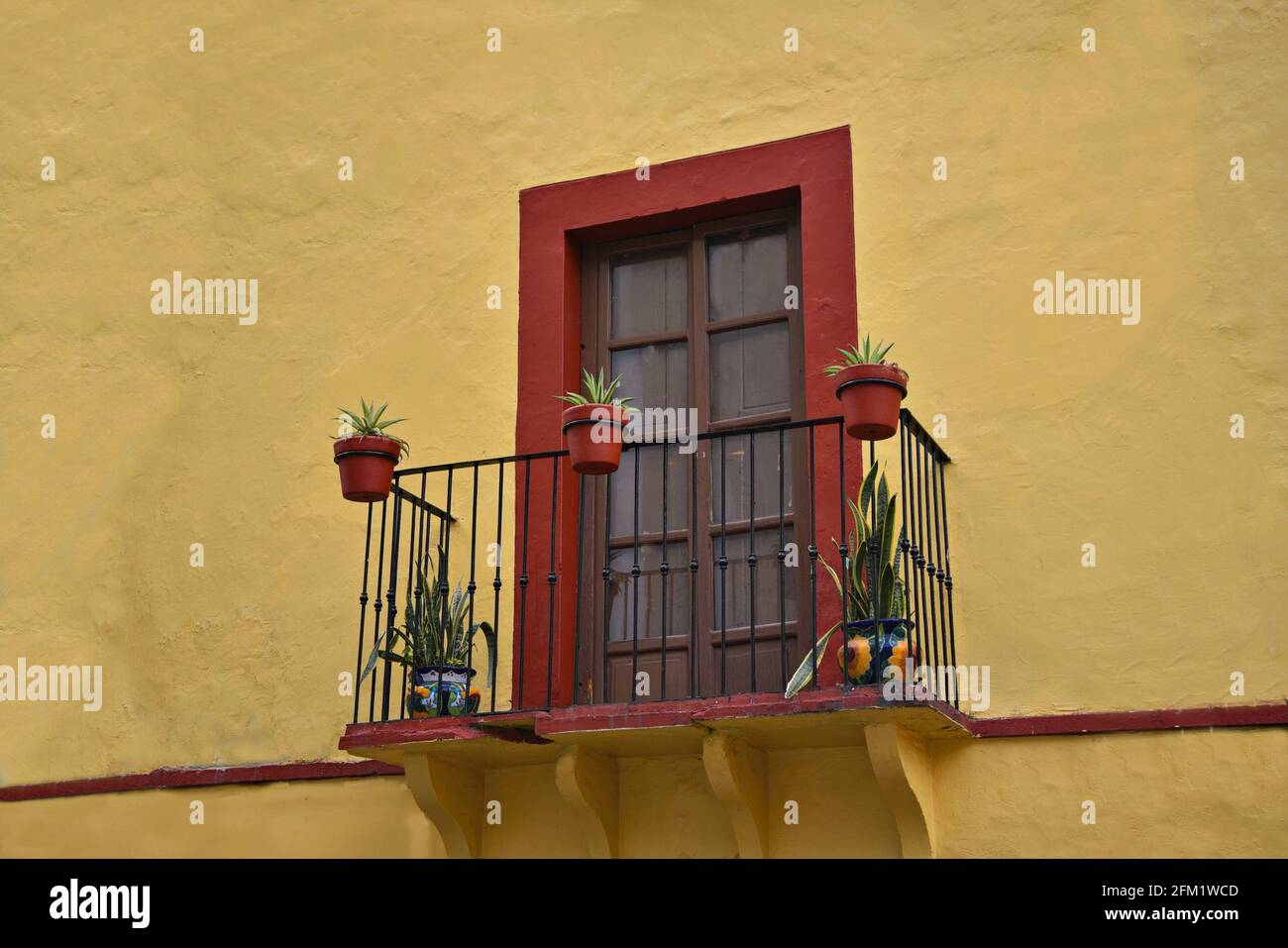 Spanish Colonial building facade with a Venetian ochre stucco wall, a ...